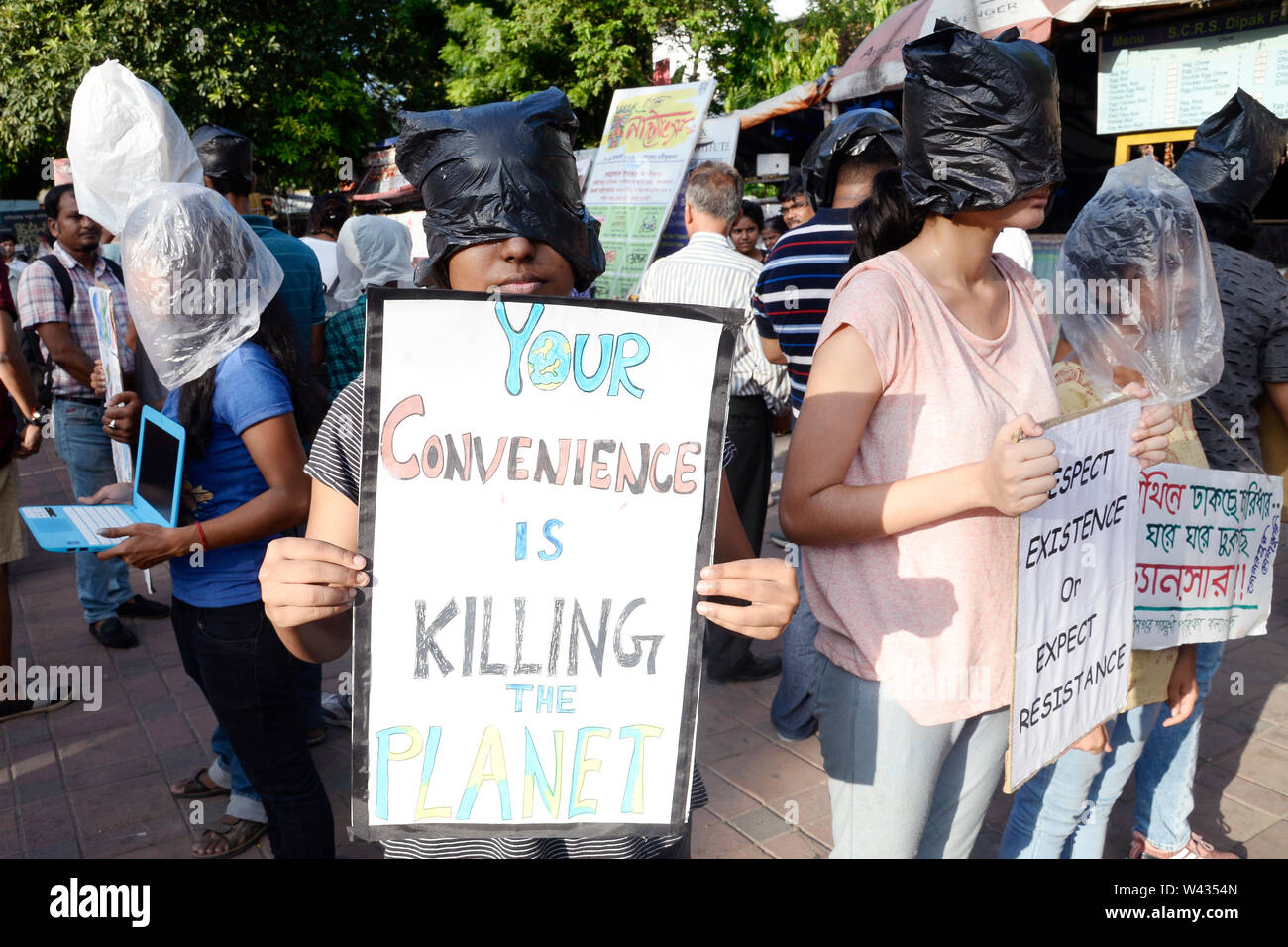 Activist of Friday for Future cover their face with plastic and holds ...