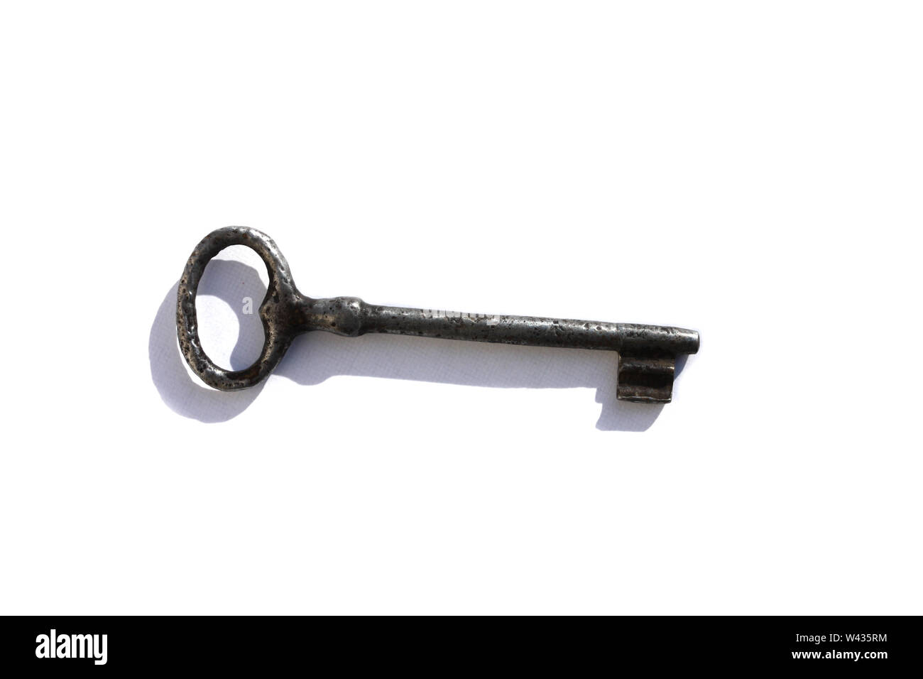 Old big key with shadow over white Stock Photo - Alamy