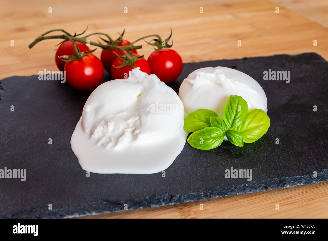 Composition of tomatos, basil and burrata cheese handmade in Puglia ...