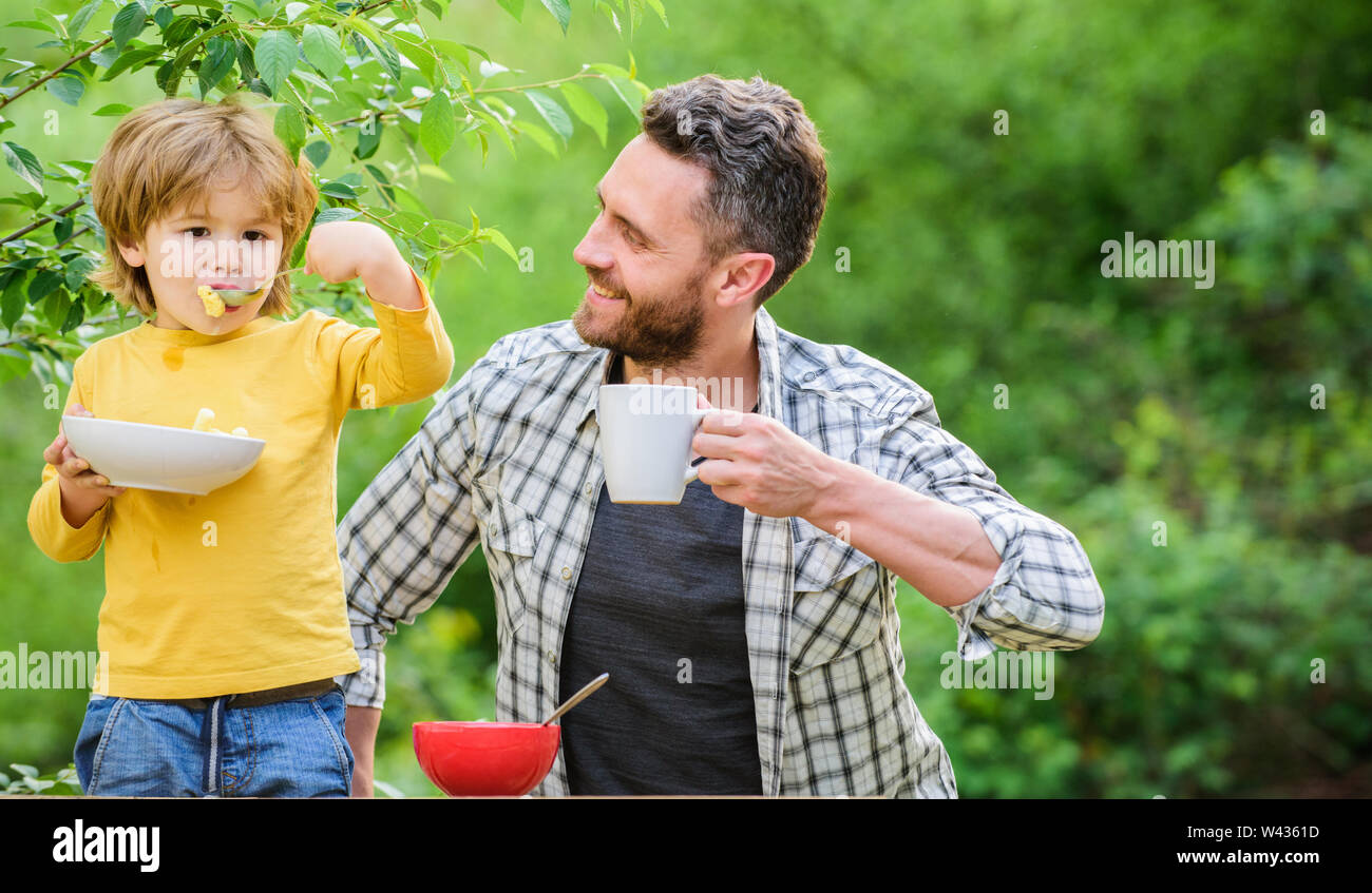 Father son eat food and have fun. Little boy and dad eating. Nutrition ...