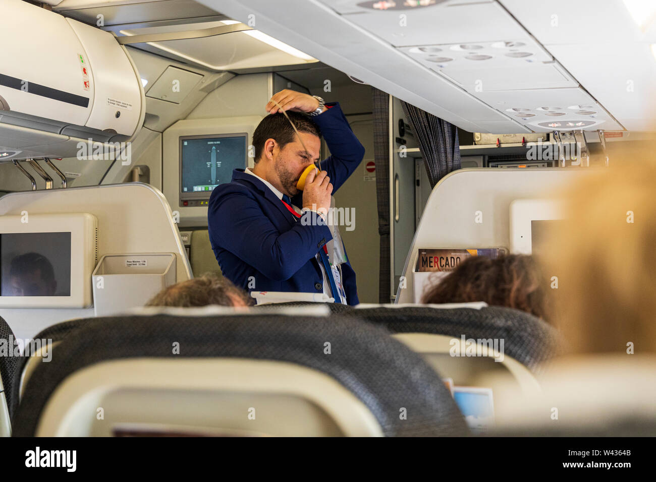 Cabin crew demonstrating an oxygen mask in the safety demonstration on ...