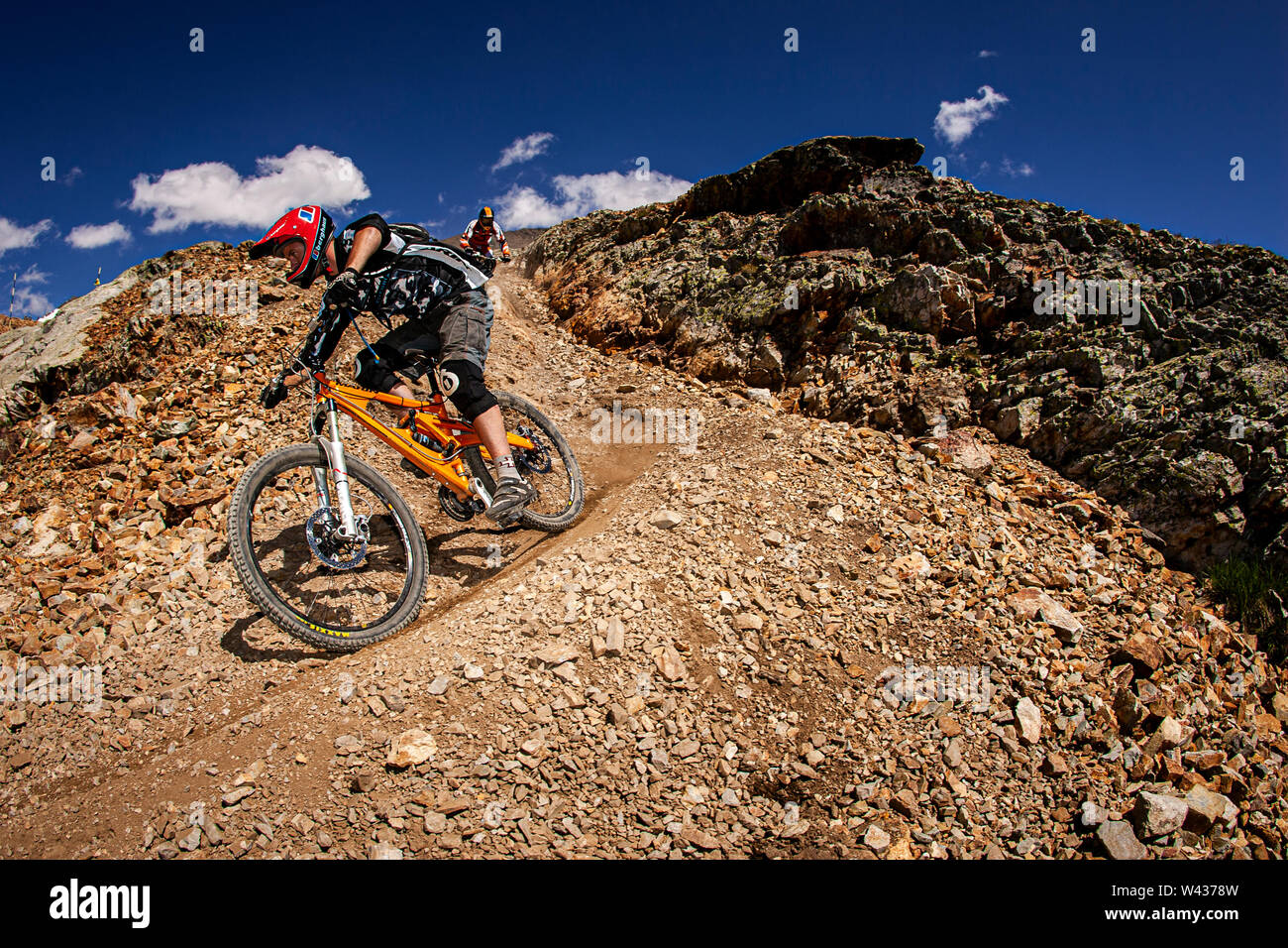 Mountain bikers riding barren and rocky trails at high altitude Stock ...