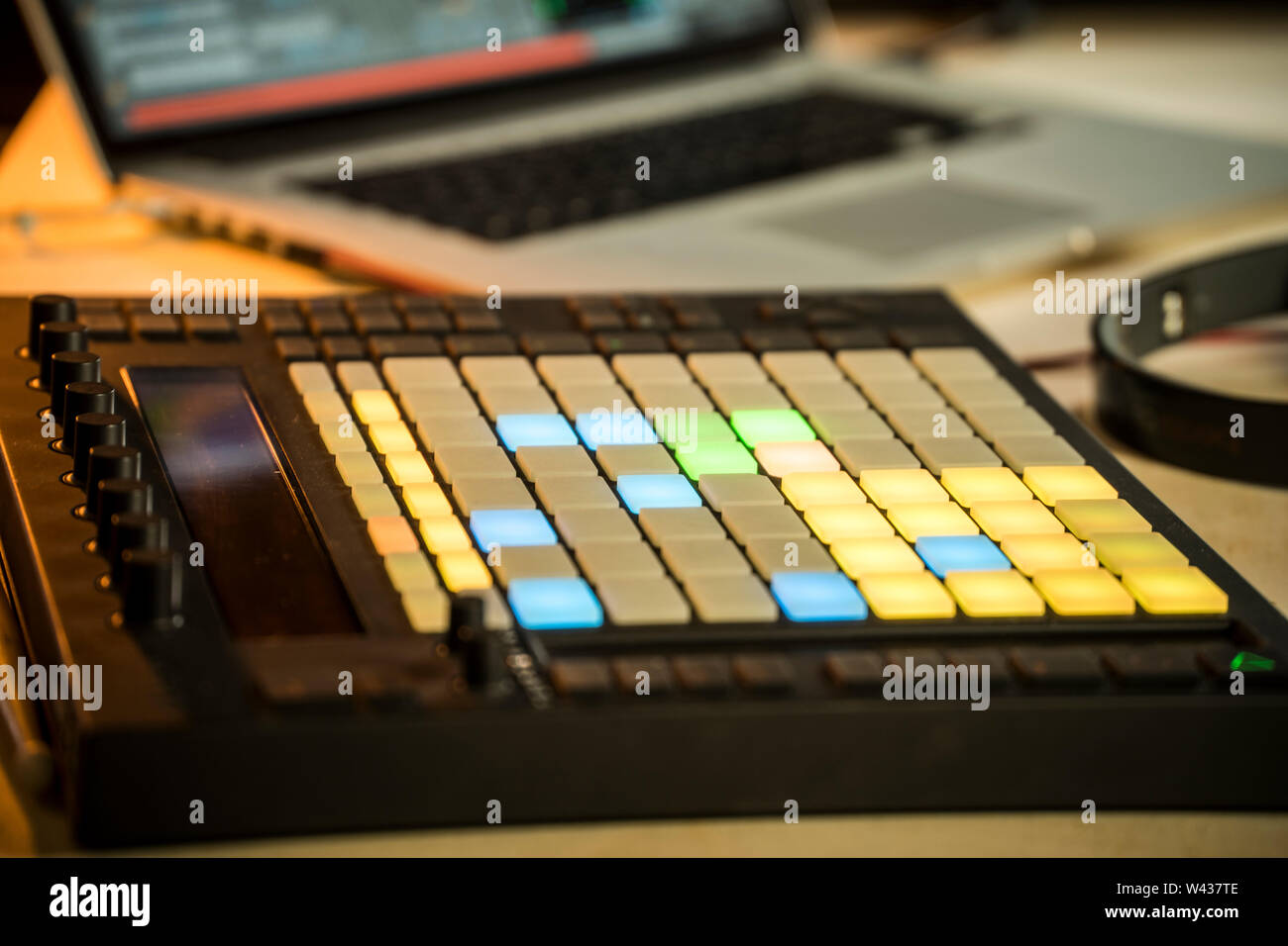 Electronic music production in a home studio. Closeup of coloured LED ...