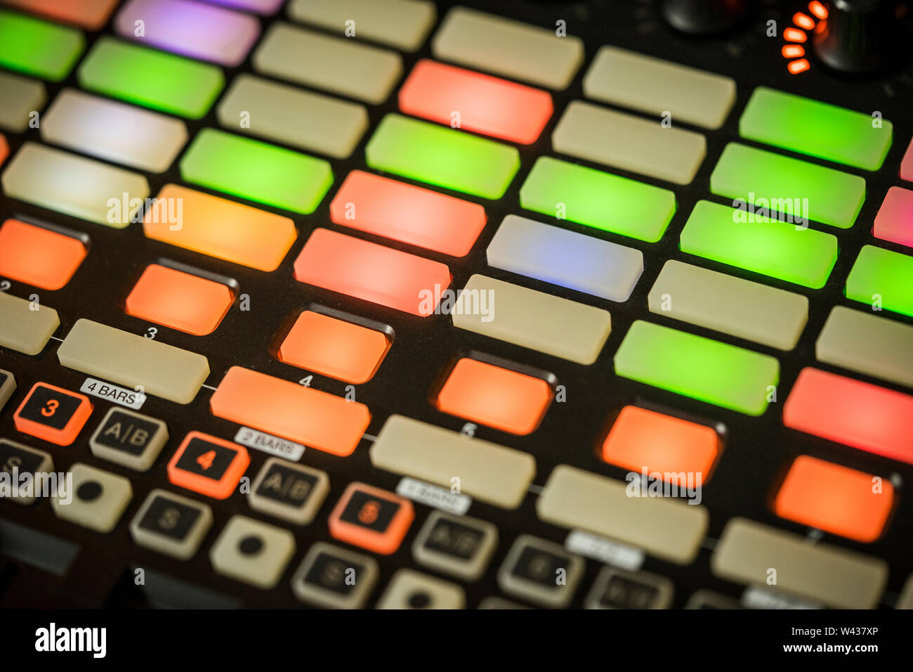 Electronic music production in a home studio. Closeup of coloured LED ...