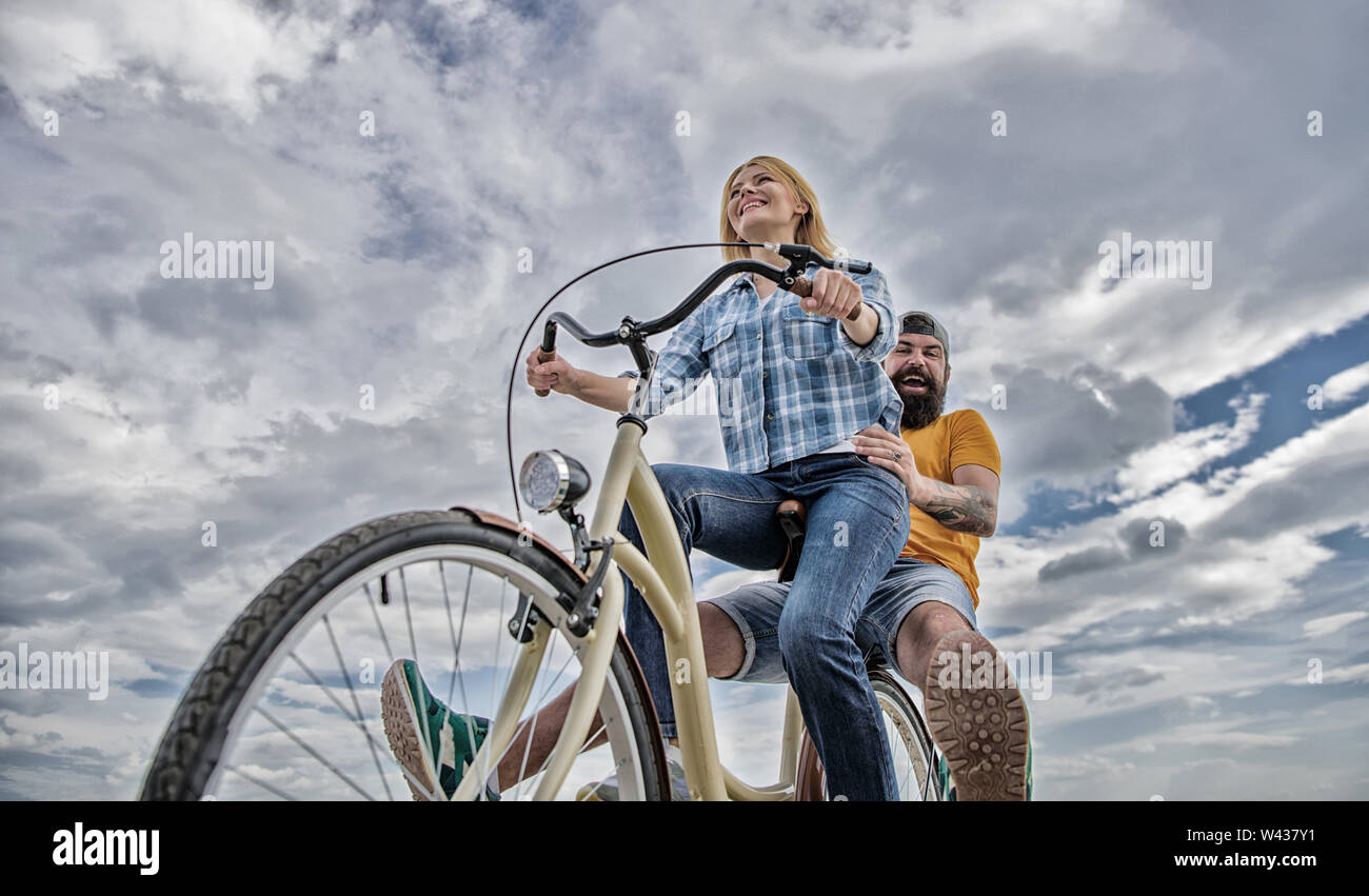 Youth have fun riding bike sky background. Enjoy summer holidays ...