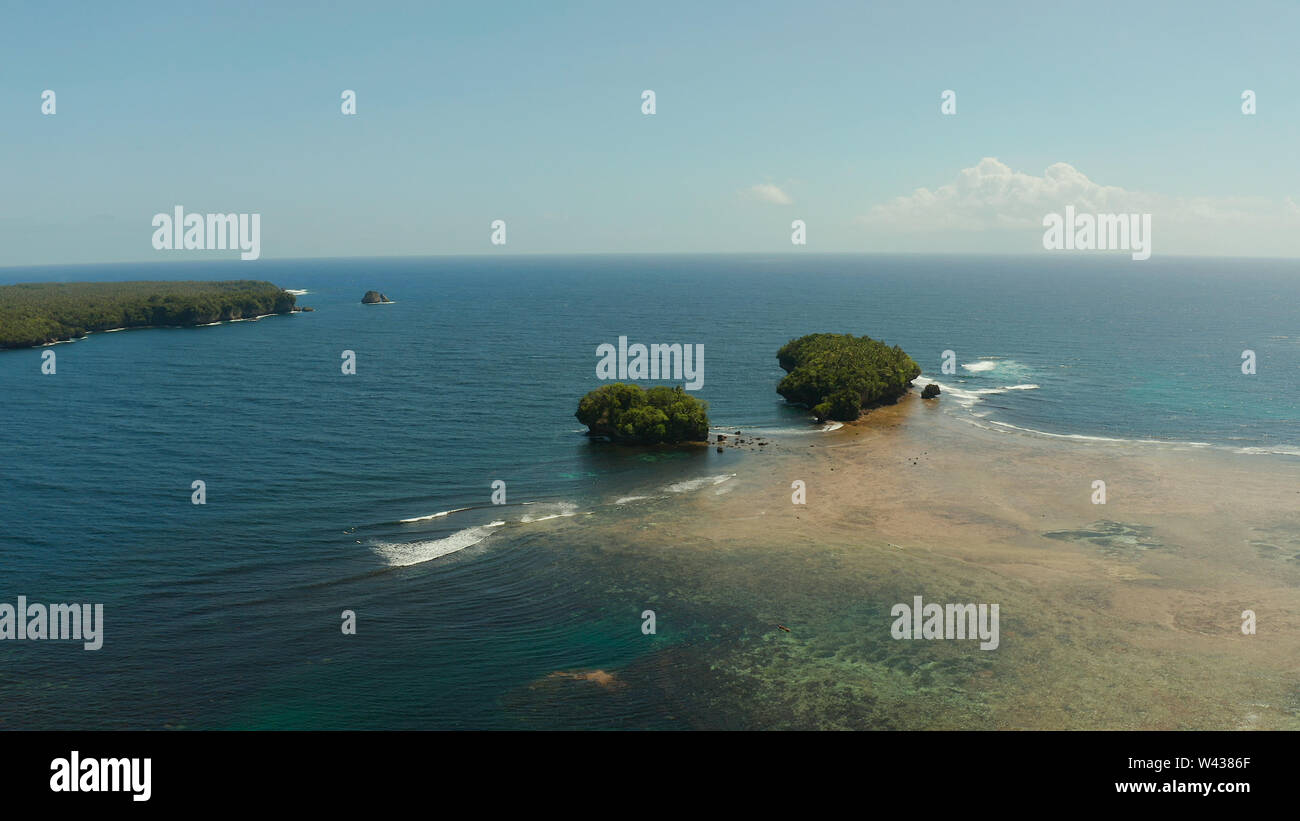 Tropical islands in the ocean with waves crashing on the shore, top ...