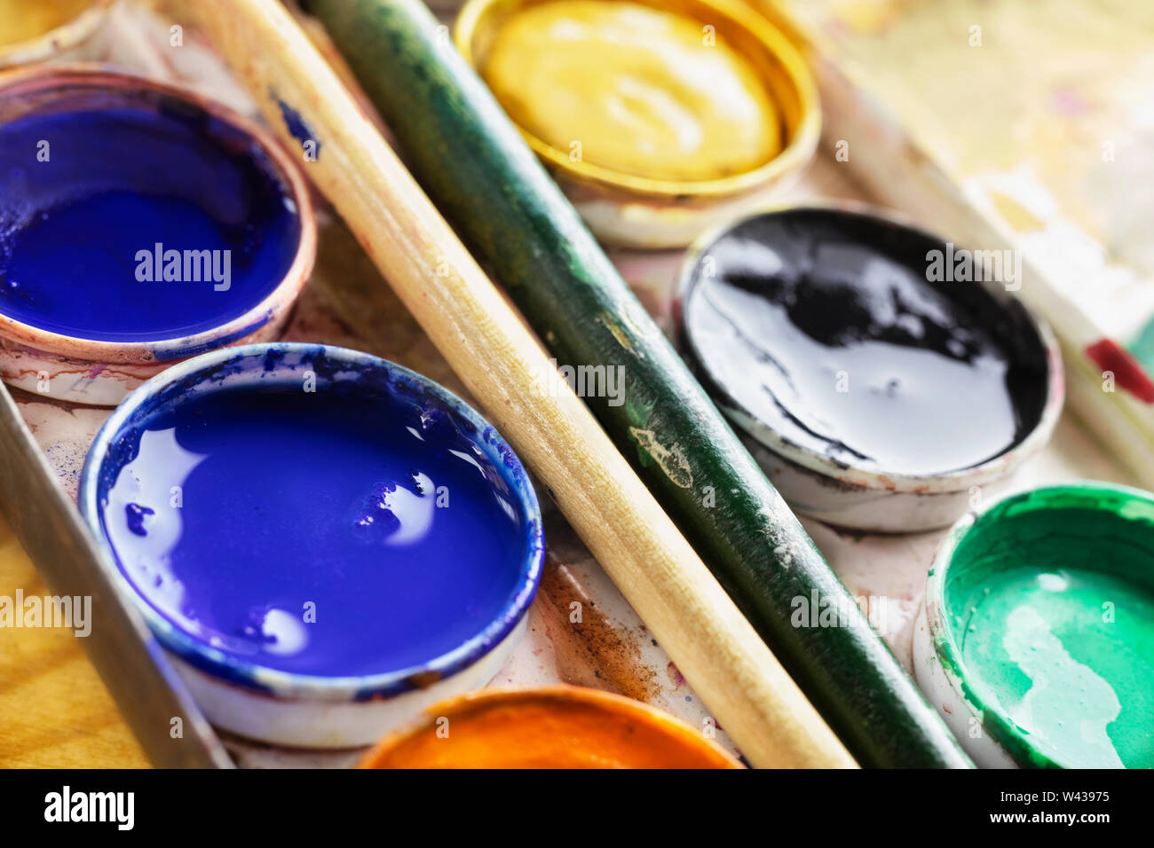 Watercolors in the paintbox ,blue , yellow and green used colors in ...