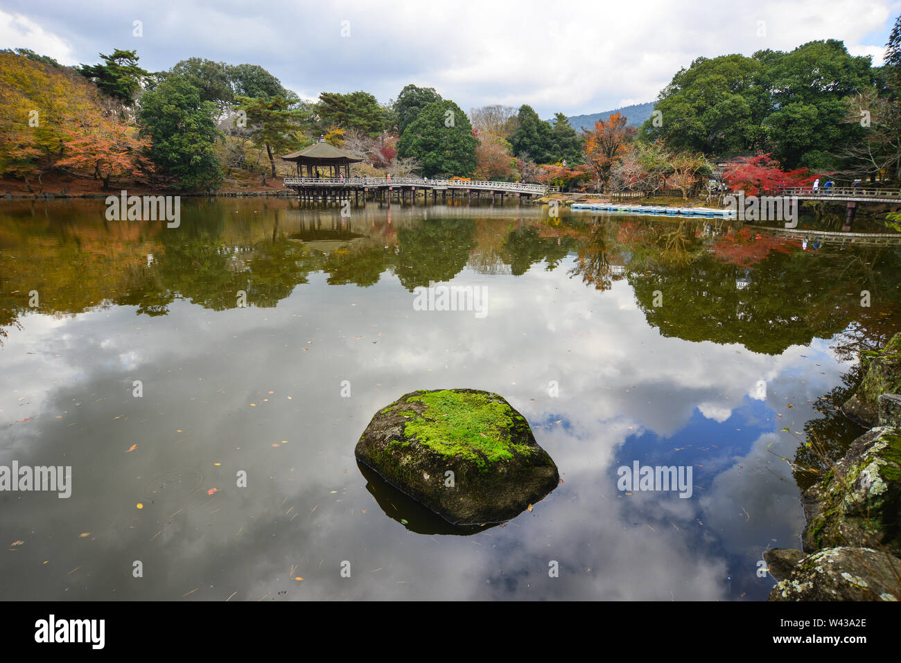 View of Nara park with the wooden bridge on the lake at autumn in Nara ...