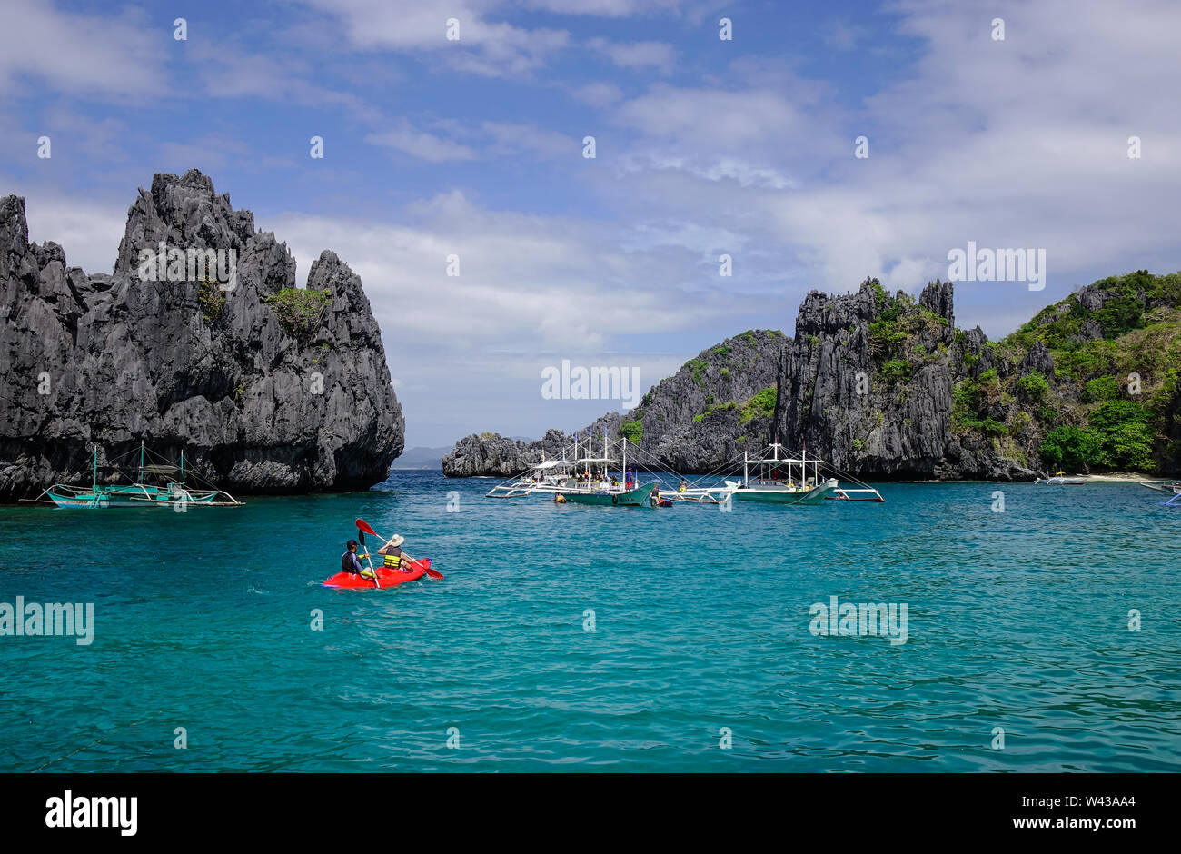 Palawan, Philippines - Apr 5, 2017. People rowing kayaks at blue lagoon ...