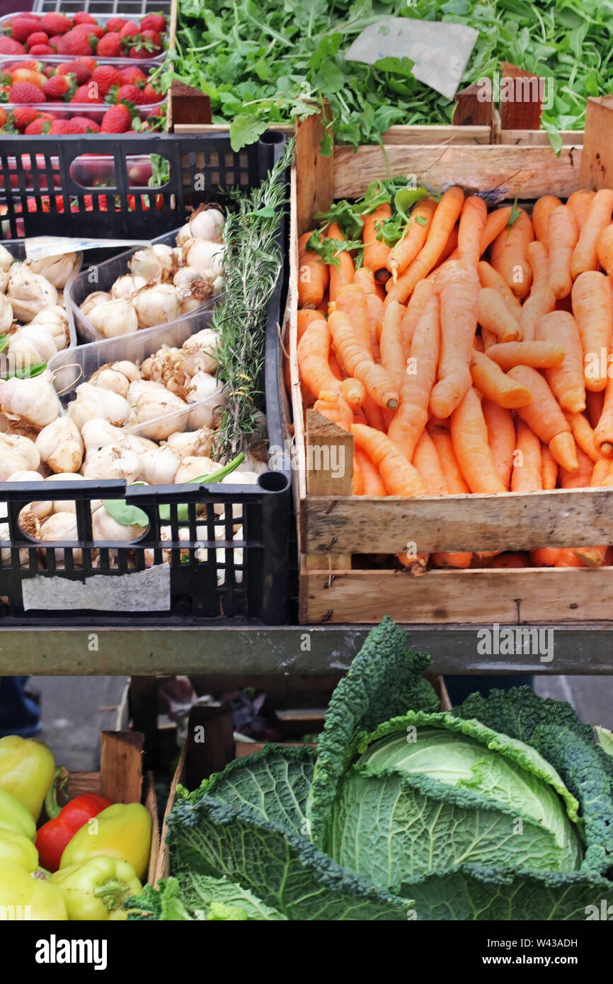 Fresh organic food piles in crates sold on market stall Stock Photo - Alamy