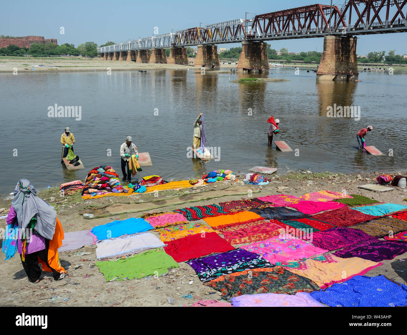 Agra, India - Jul 13, 2015. People washing and drying colorful sarees ...