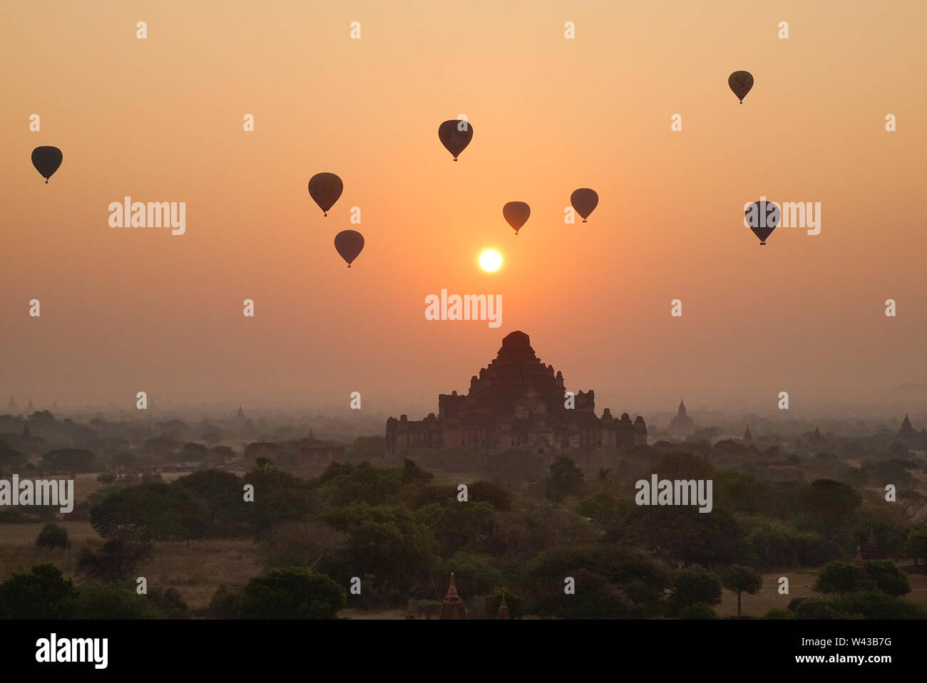 Buddhist temples with hot air balloons at sunrise in Bagan, Myanmar ...