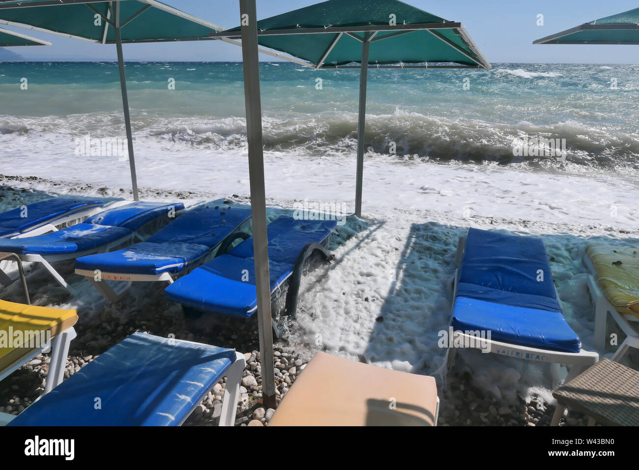 Windy beach with white umbrellas hi-res stock photography and images ...