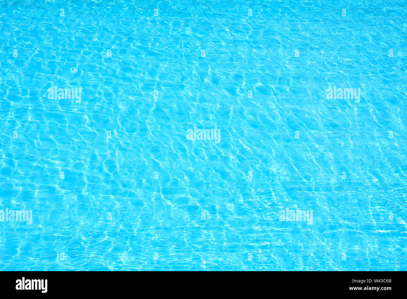 Clear transparent pool water background. Sun reflections in pool water ...