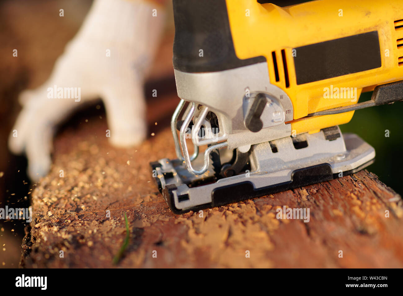 Carpenter is cutting wood with fret saw, close-up Stock Photo - Alamy