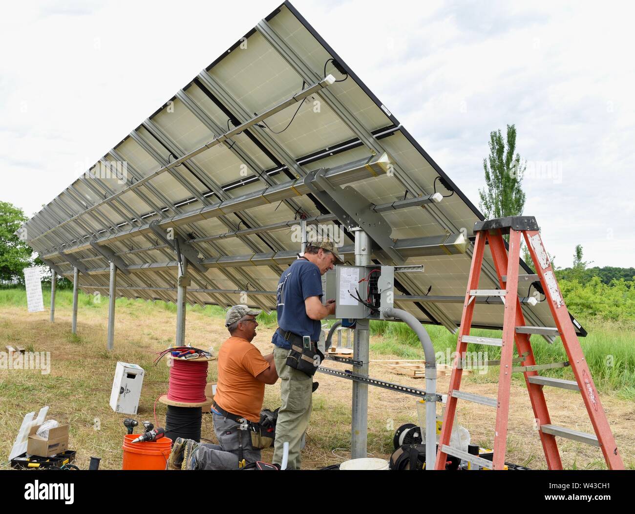 Certified electricians installing a solar electric (photovoltaic ...