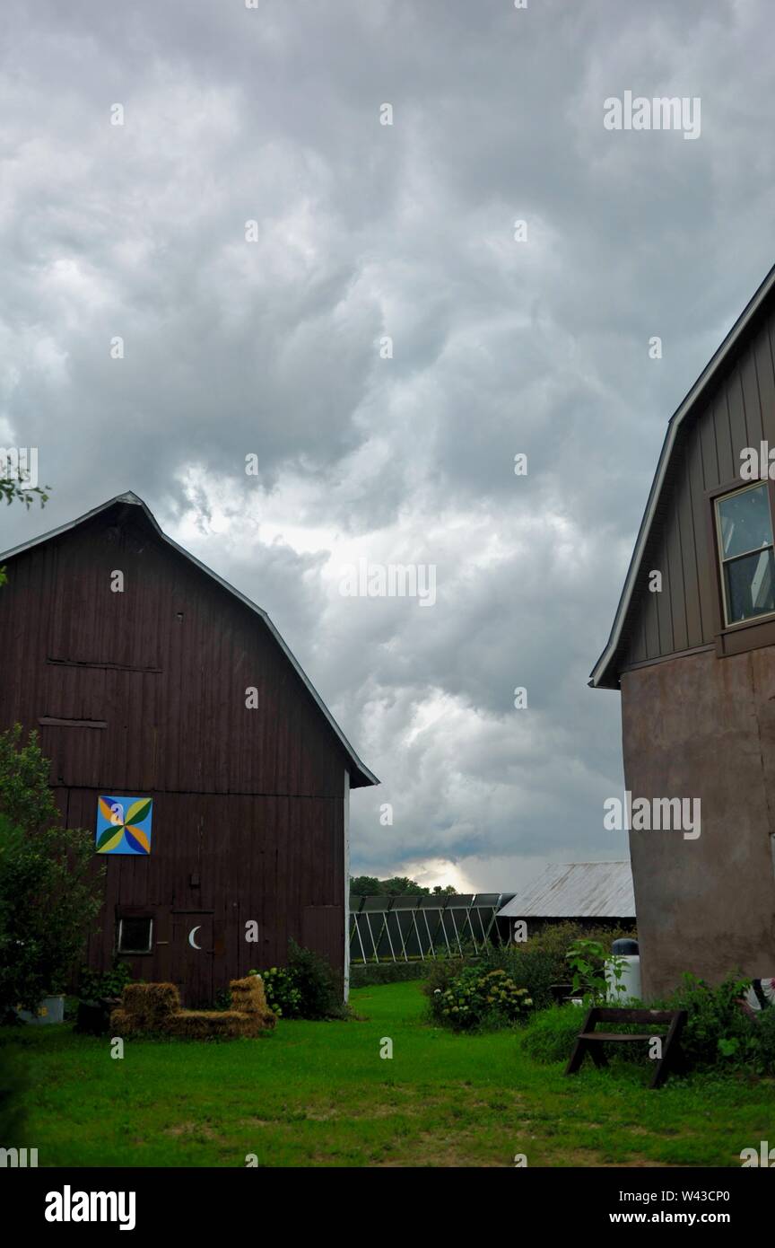 Severe weather and dark, threatening storm clouds swirl over a small ...