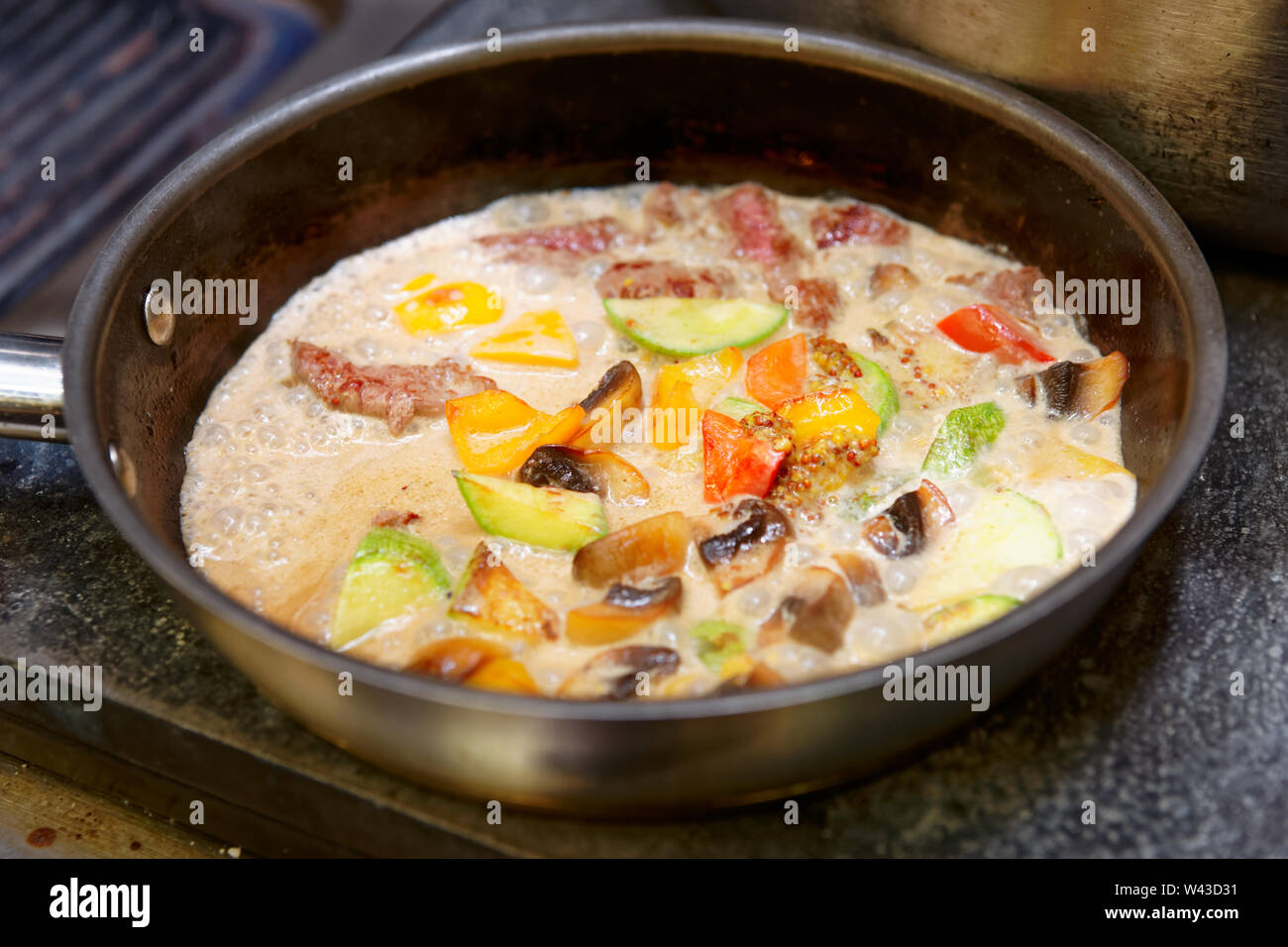 Meat and vegetables being cooked in cream Stock Photo - Alamy