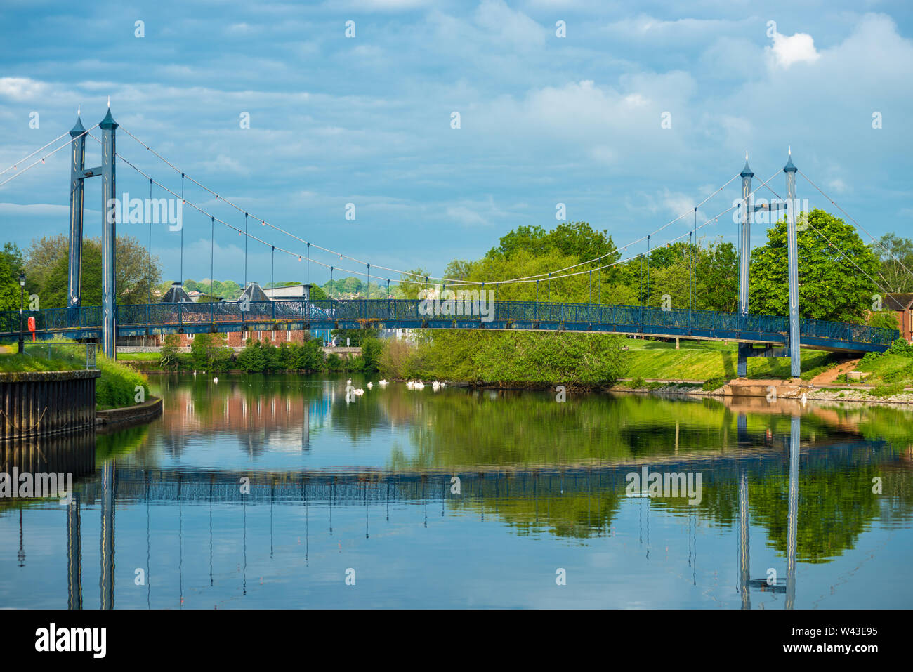 Suspension bridge at Exeter Quay or Quayside in early morning light ...