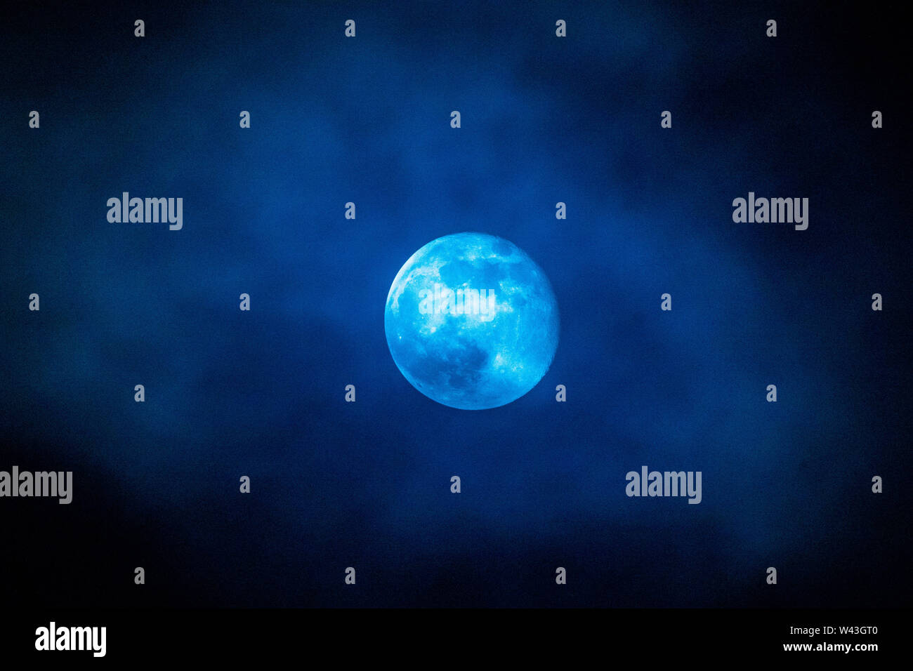full moon with clouds and blue light in february 2019 Stock Photo - Alamy