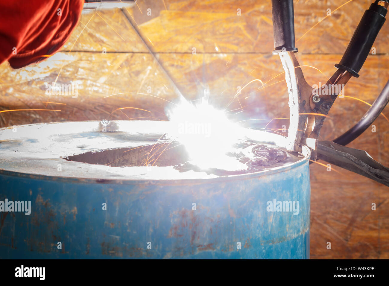 Worker with red glove to protect spark light with welding Process with ...