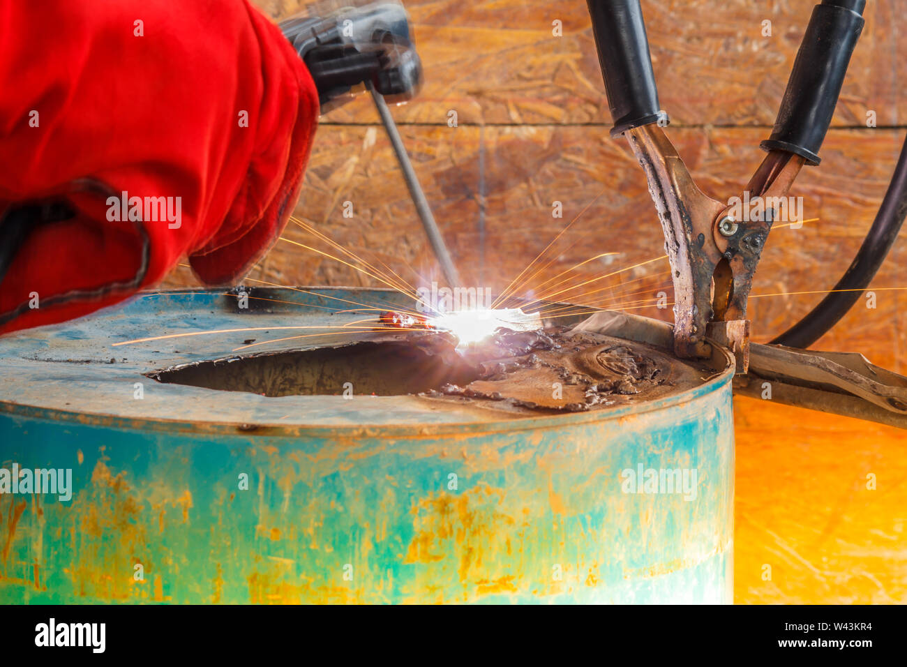 Worker with red glove to protect spark light with welding Process with ...