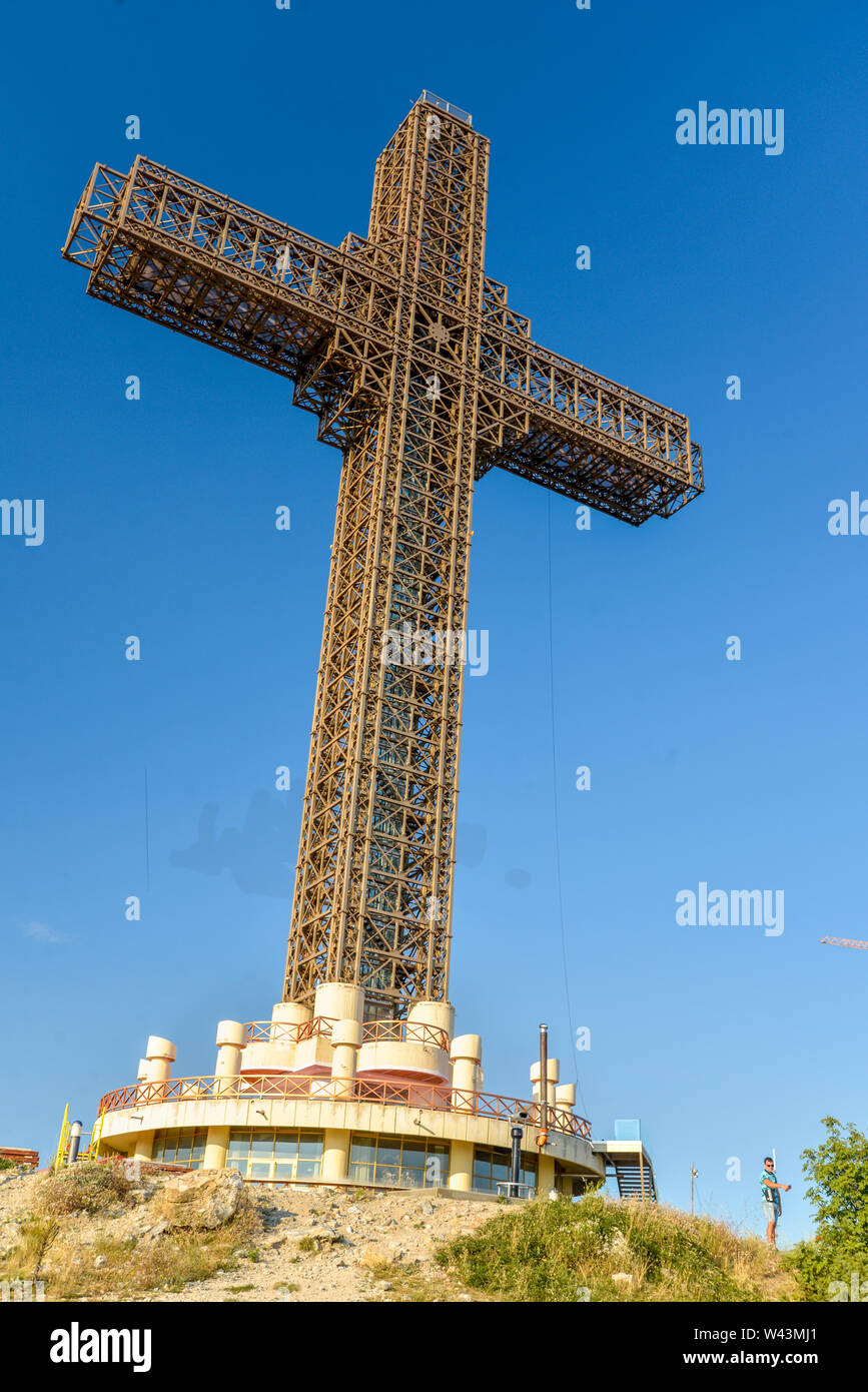 Man stands beneath the Millennium Cross in Skopje, a 66 meter tall ...