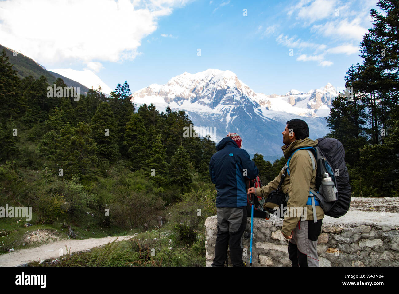 Trekkers dwelling on the majestic view of Mount Manaslu from Samagaon ...