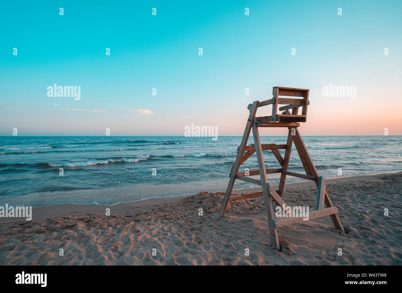 Beach with wooden lifeguard chair in sunset time Stock Photo - Alamy