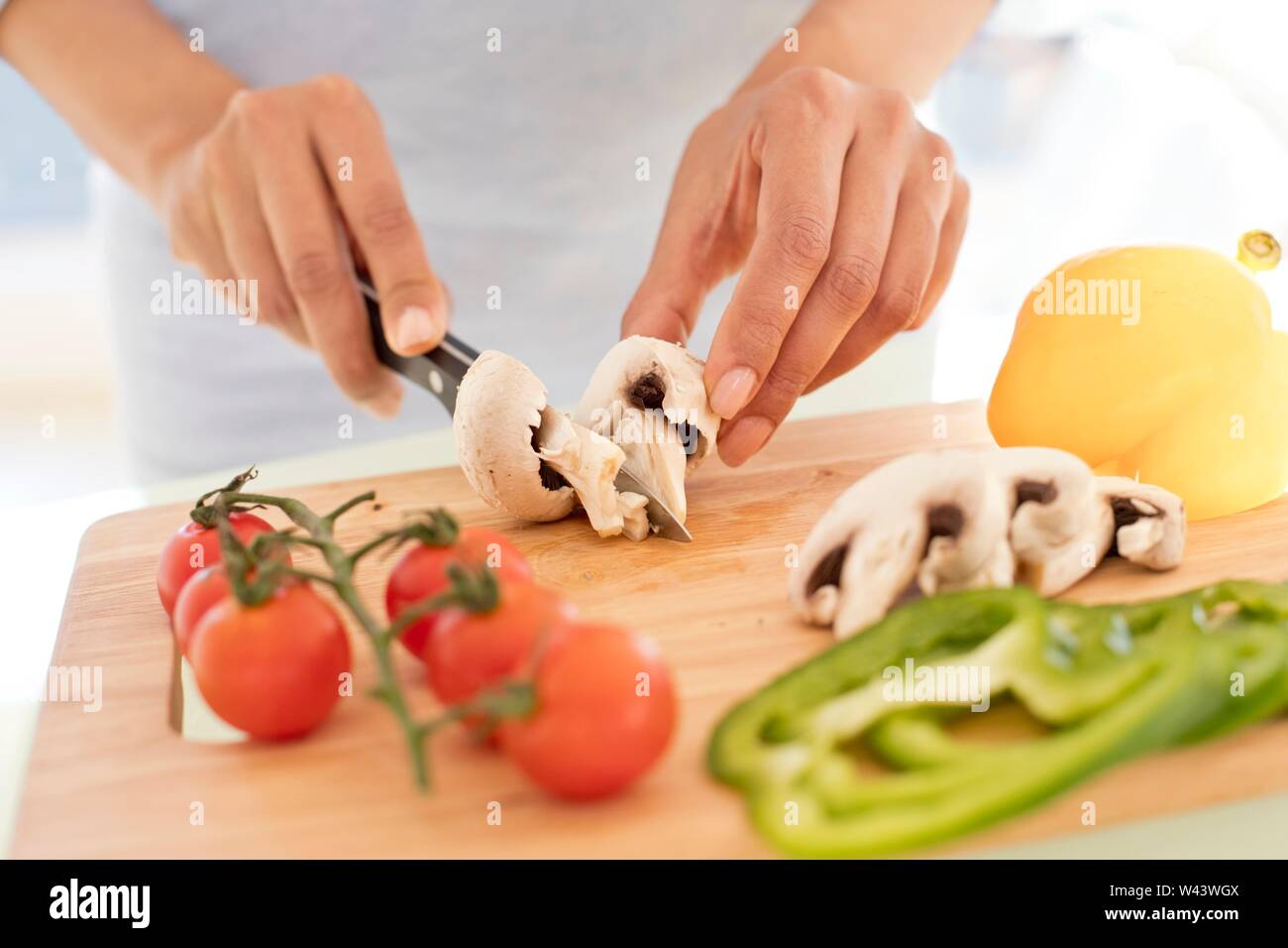Woman chopping fresh mushrooms Stock Photo - Alamy