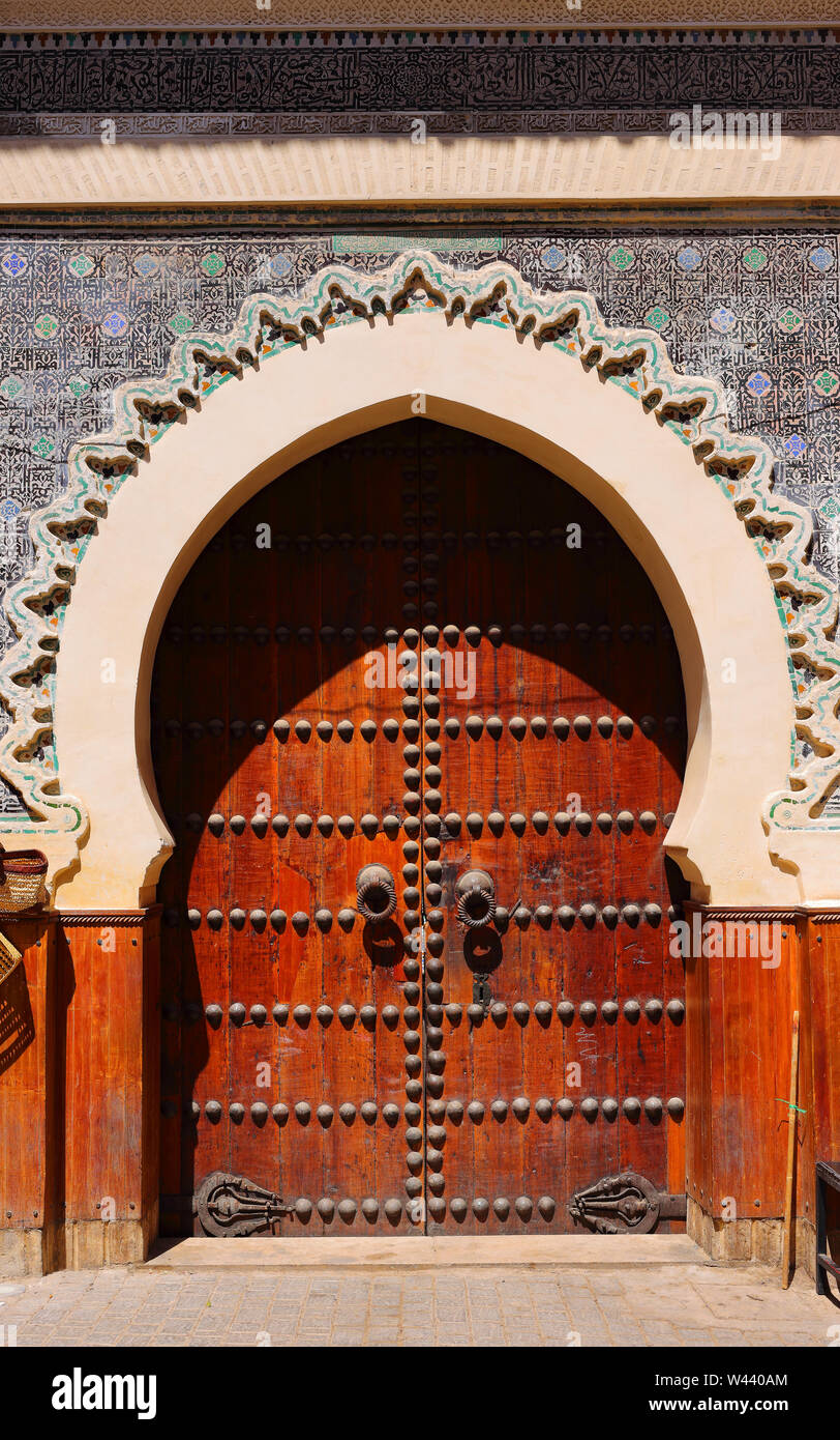 Morocco, Fez. Beautiful facade and Arabesque arched doorway and glazed ...