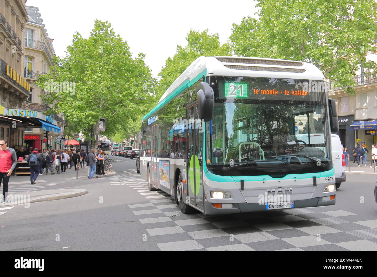 Public bus run through downtown Paris France Stock Photo - Alamy
