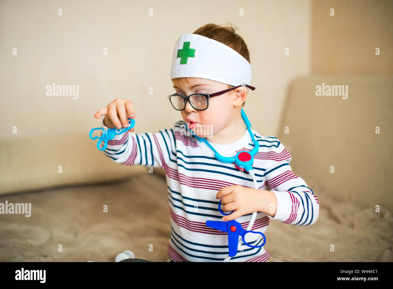 little ginger boy with glasses with syndrome dawn playing Stock Photo ...