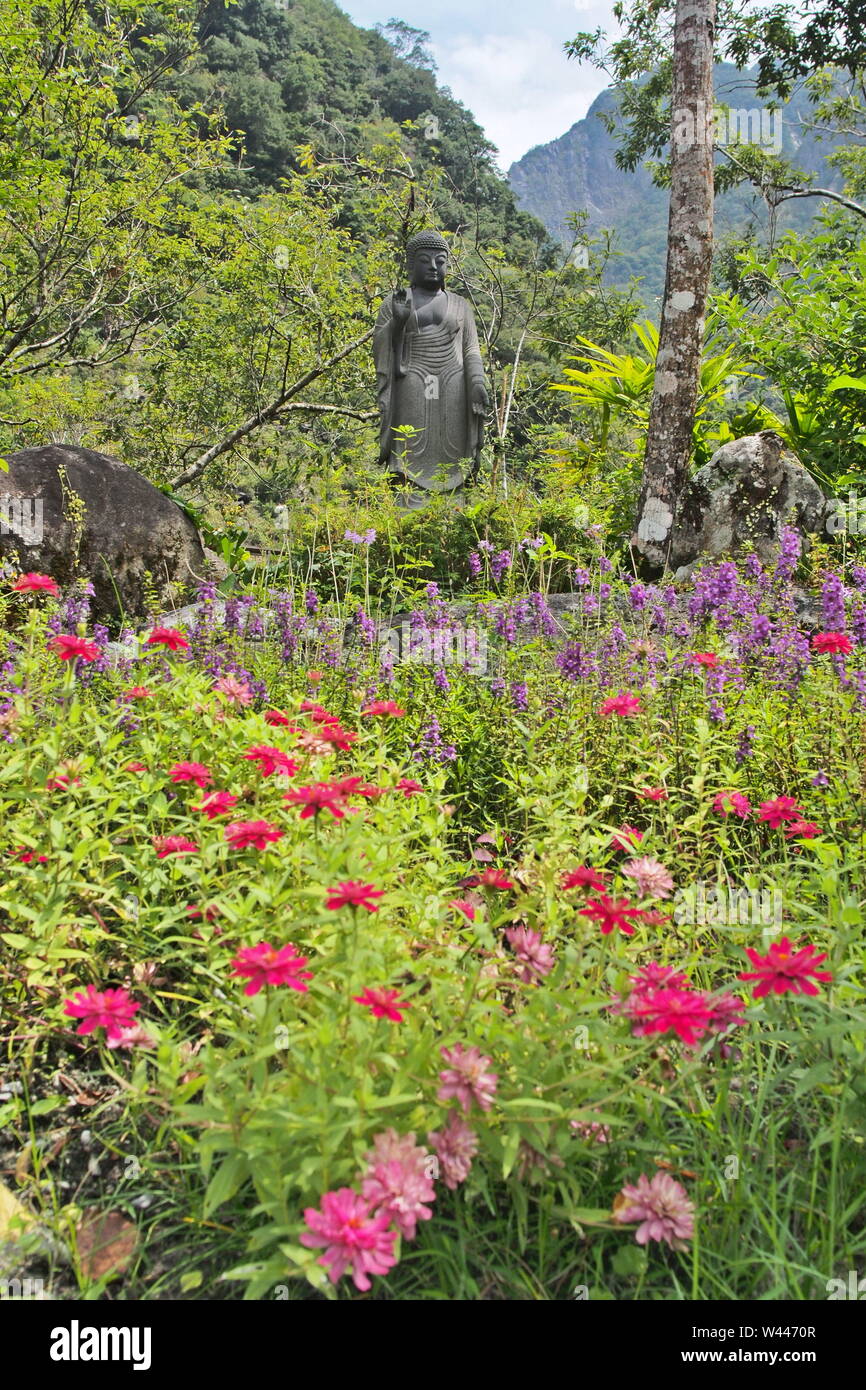 Traditional statue in flowering garden, Taiwan Stock Photo - Alamy