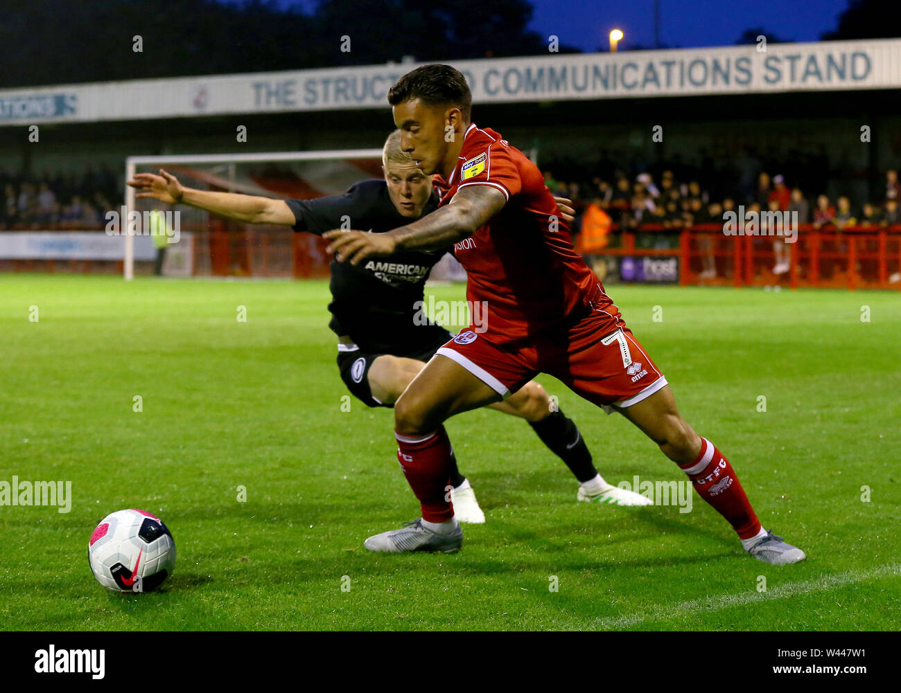 Crawley's Reece Grego-Cox (right) is challenged by Brighton's Alex ...