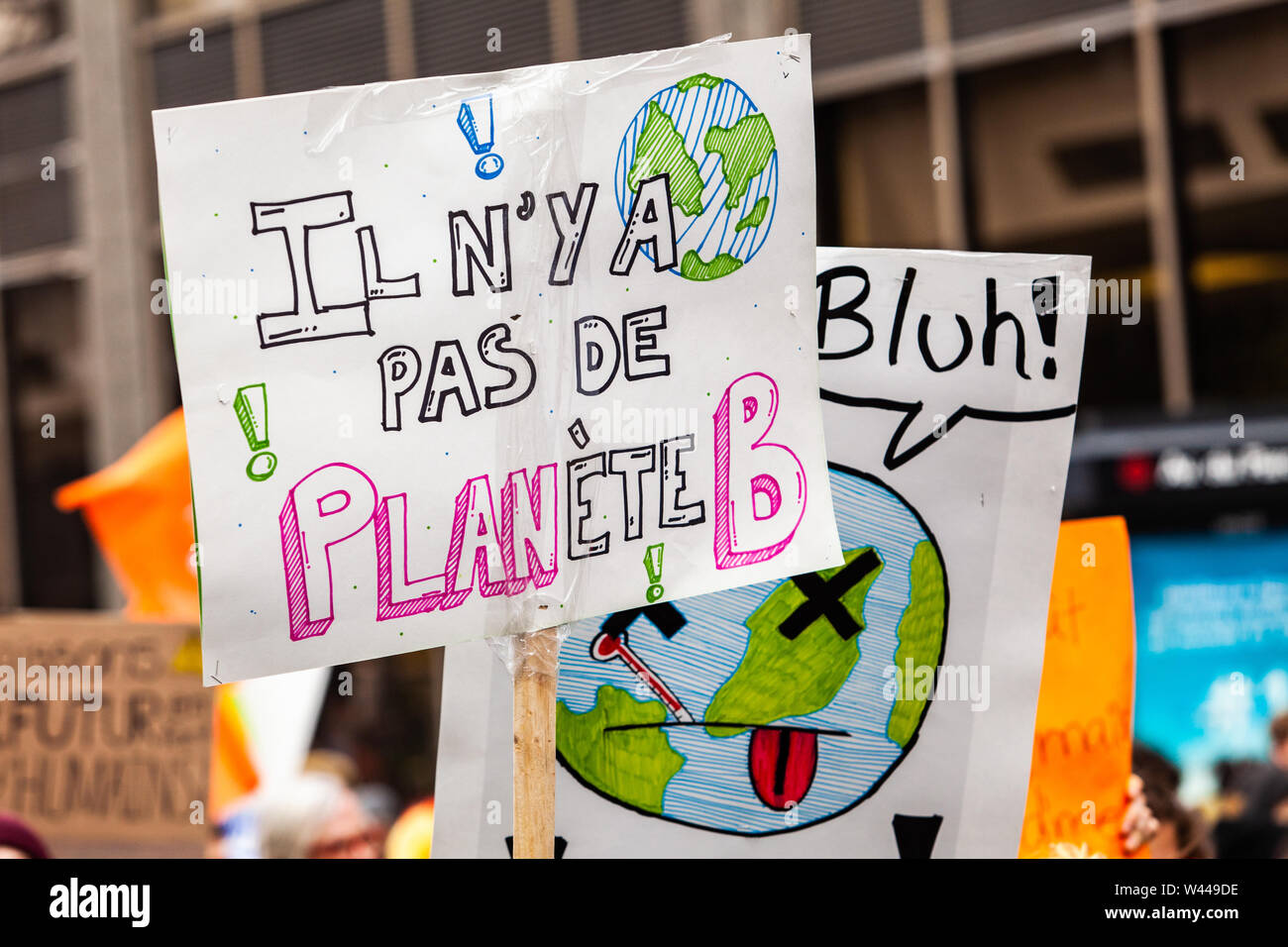 Environmental activist holds a French sign saying there is no planet b ...