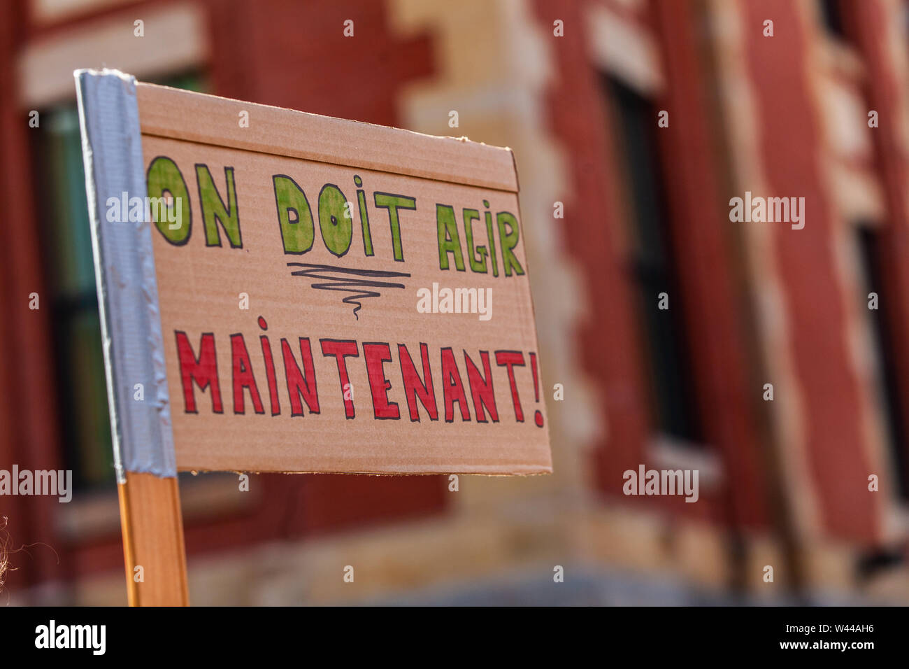 A closeup view of a French sign, saying we must act now, as ...
