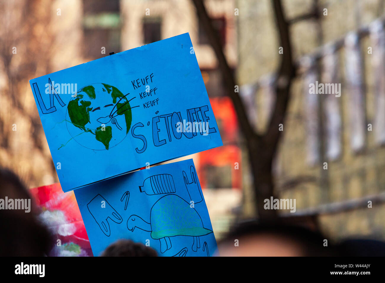 A closeup view of a French sign which depicts planet earth choking ...