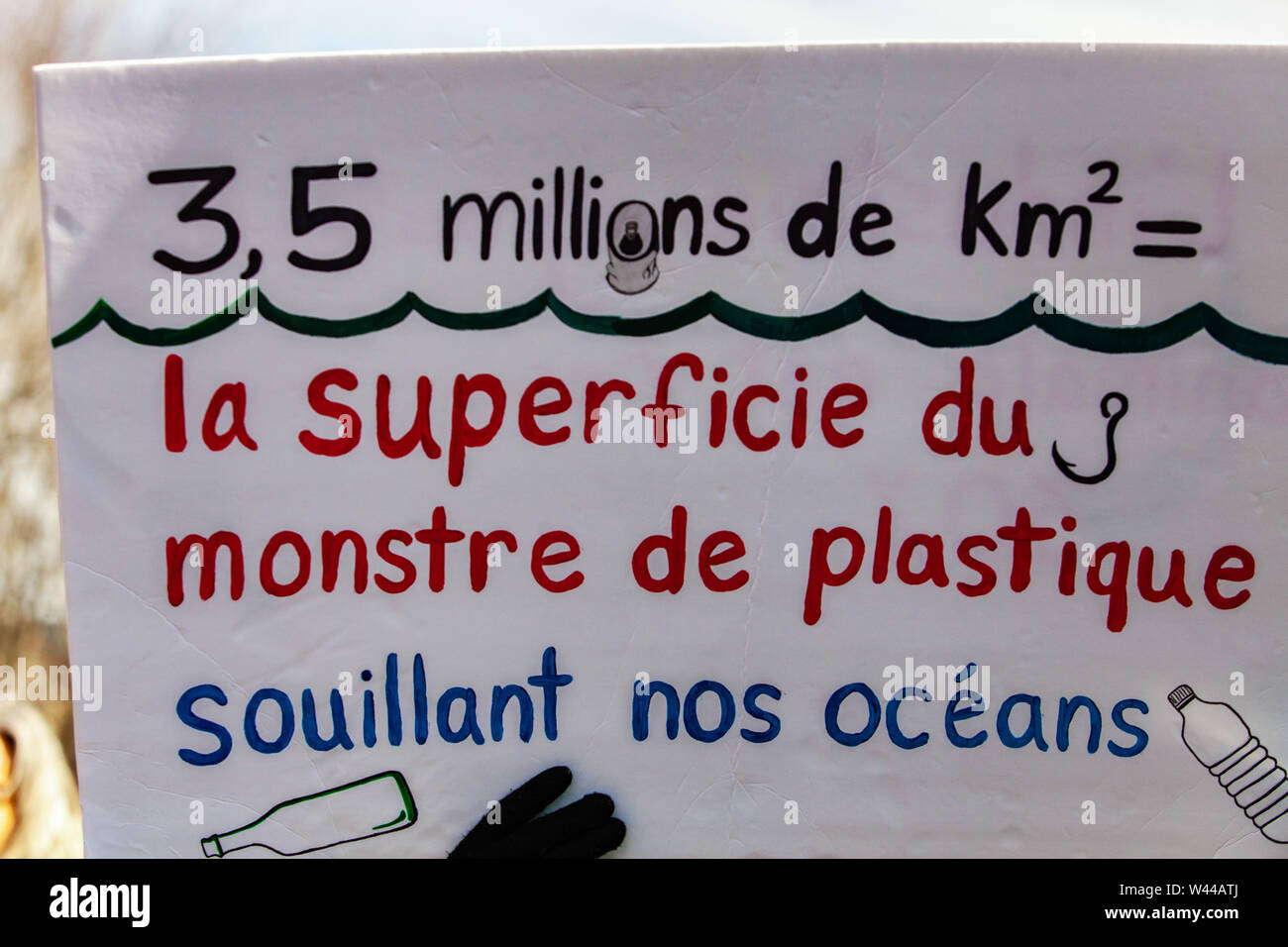 A French sign depicts sea pollution and says 3.5 million per square ...
