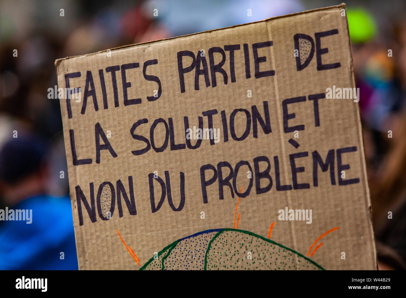 A closeup shot of a French sign, saying be part of the solution and not ...