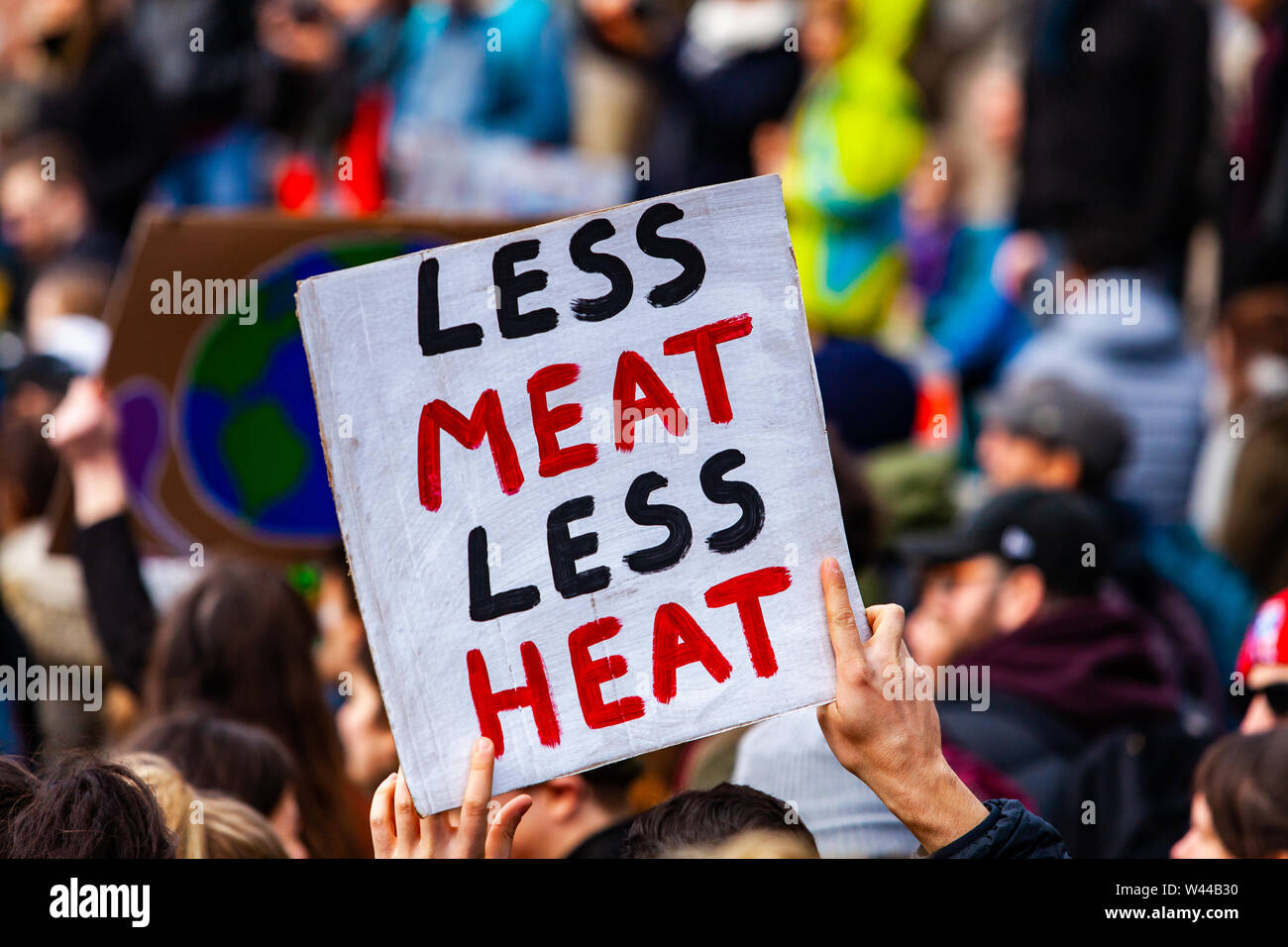 A close-up shot of a homemade poster, saying less meat less heat, being ...