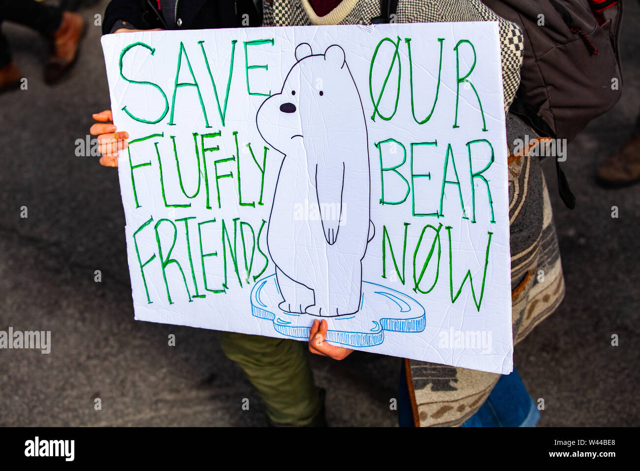 A homemade sign is seen closeup, saying save our fluffy polar bear ...
