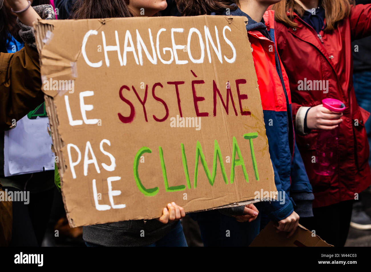 A cardboard French placard, saying change the system not the climate ...