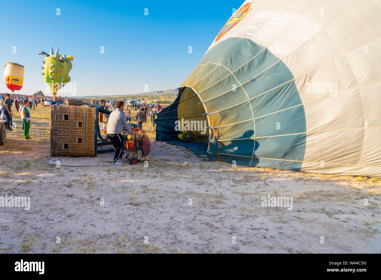 Cappadocia / Turkey - July 07 2019: Crew at sunset prepare hot air ...