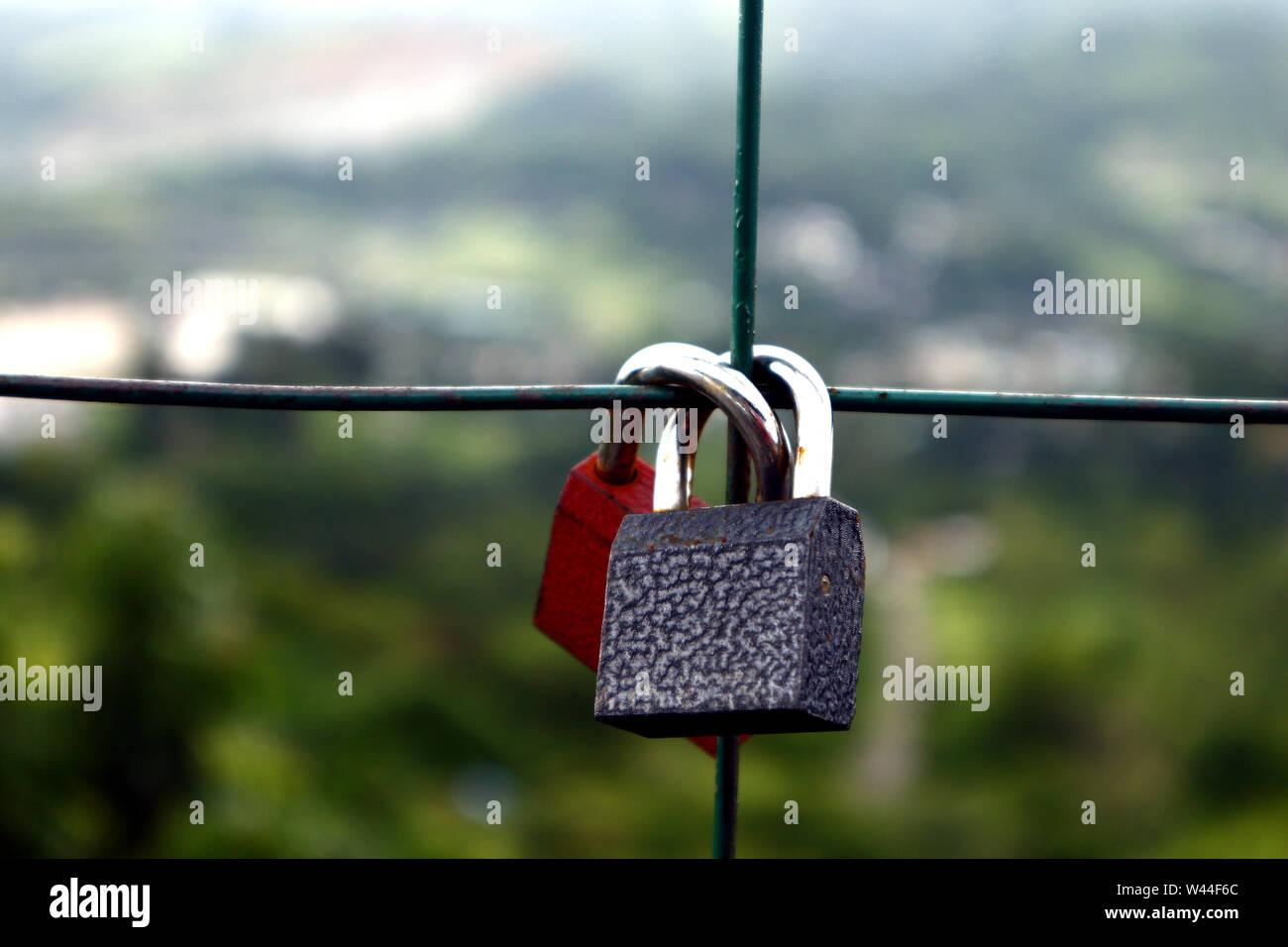 Close up photo shot of padlocks on a wire fence as a symbol of promise ...