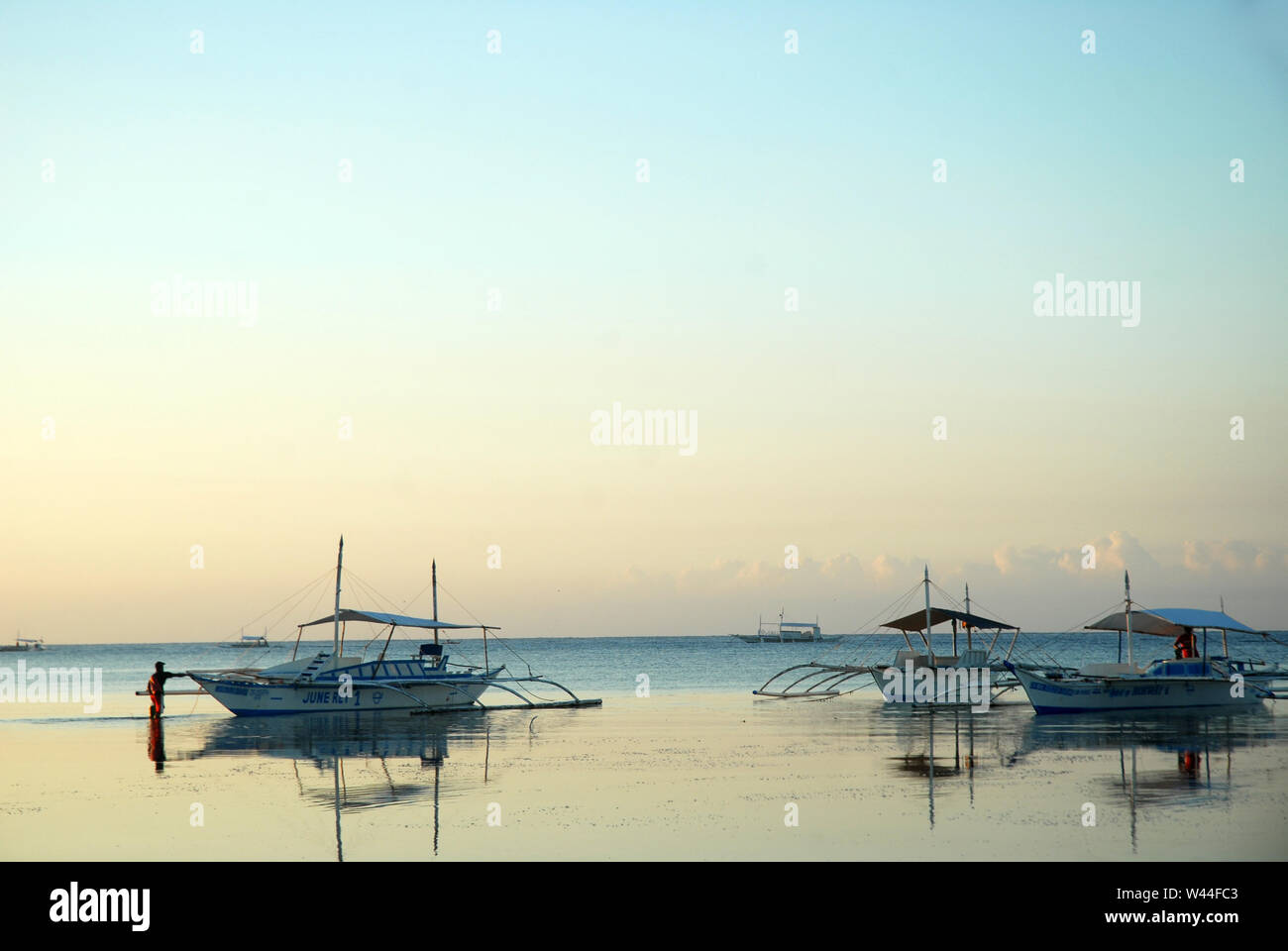 Sunrise on the beach with banca boats and fisherman at Panglao Island ...