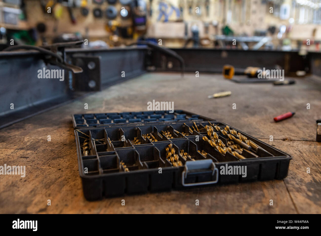 A closeup view of a blacksmith's drill bits stored in plastic container ...
