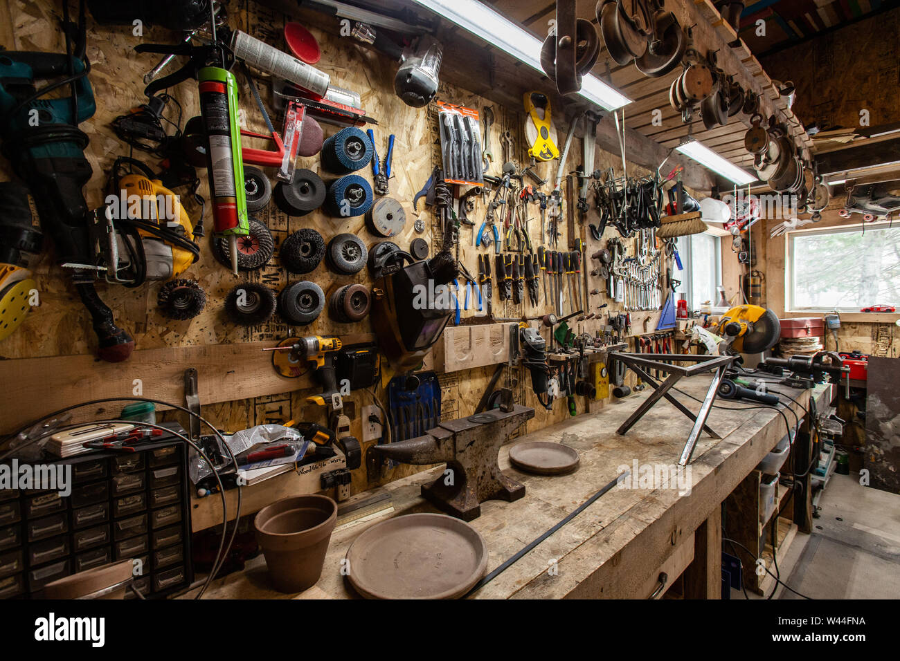 A variety of metalwork tools including abrasive cutting discs hang over ...