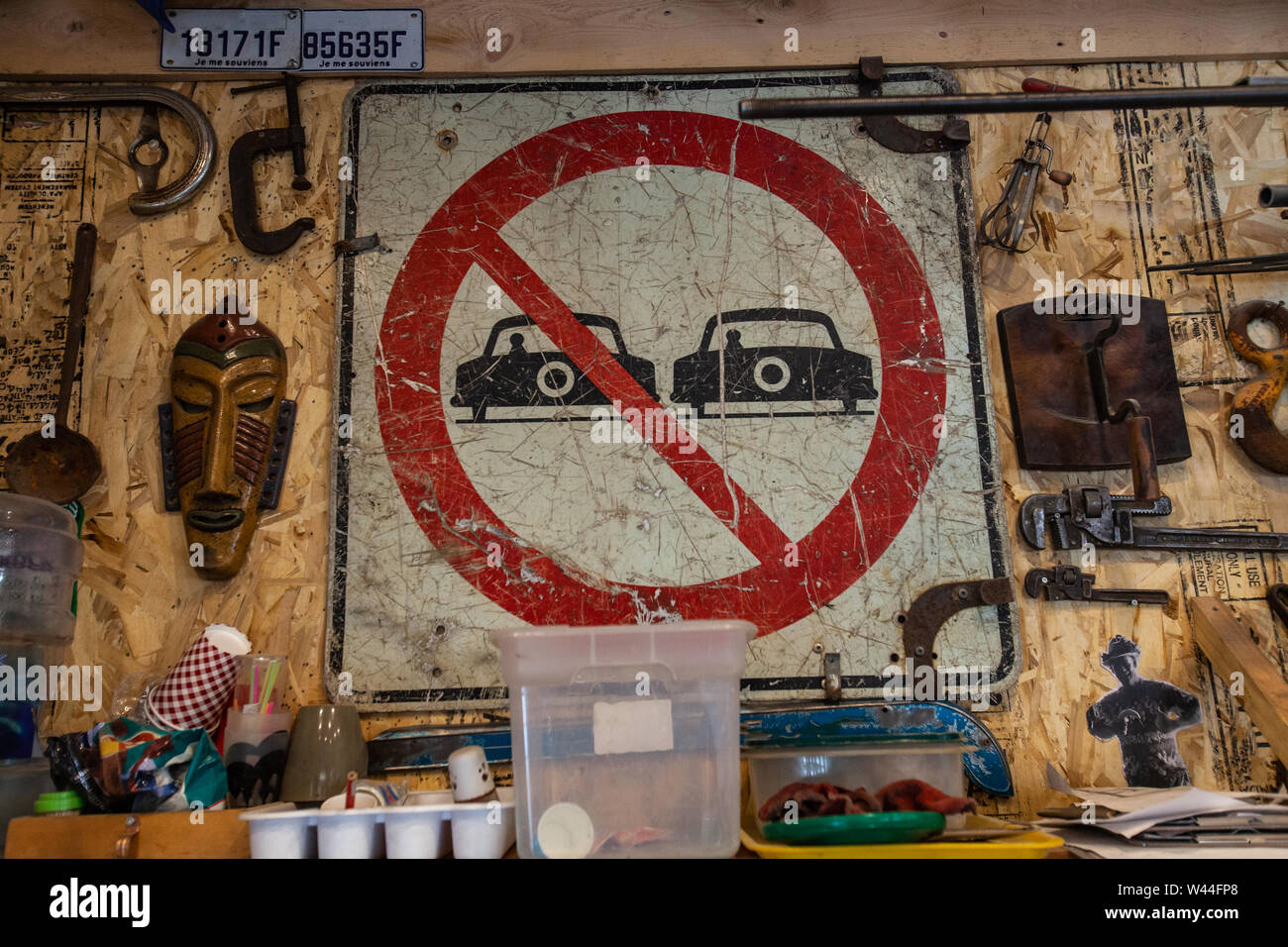 A closeup view of a vintage traffic sign, heavily marked, hanging on a ...