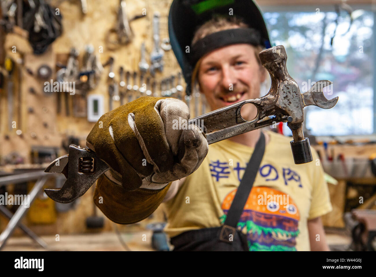 A front portrait view of a skilled tradesman showing his handmade multi ...